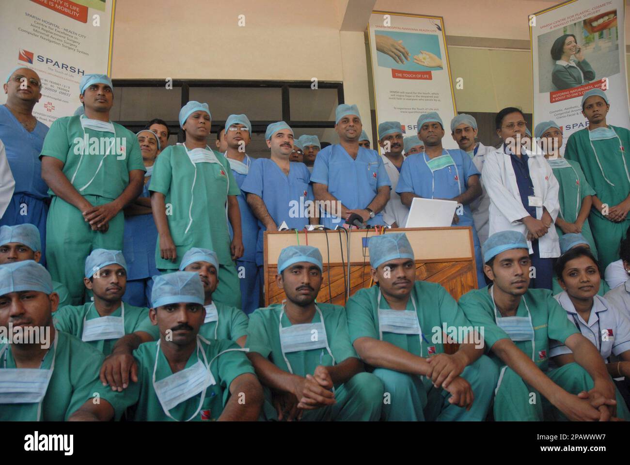 Members of the team pose for photographs after the completion of 24 ...