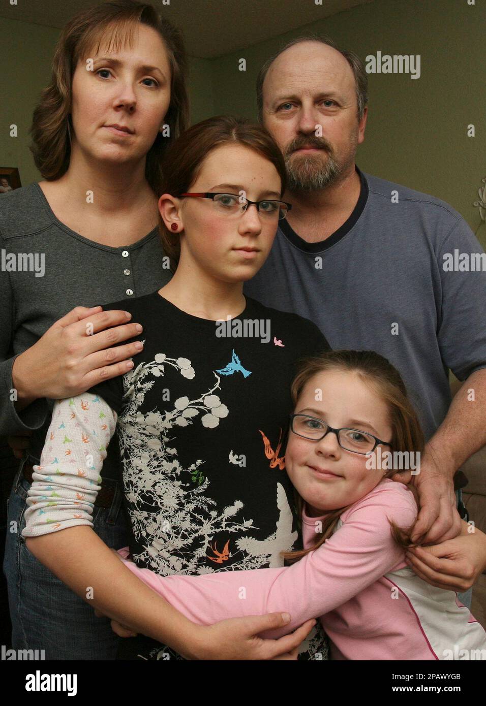 Eighth-grader Megan Coulter gets a family hug from her mother Melissa ...