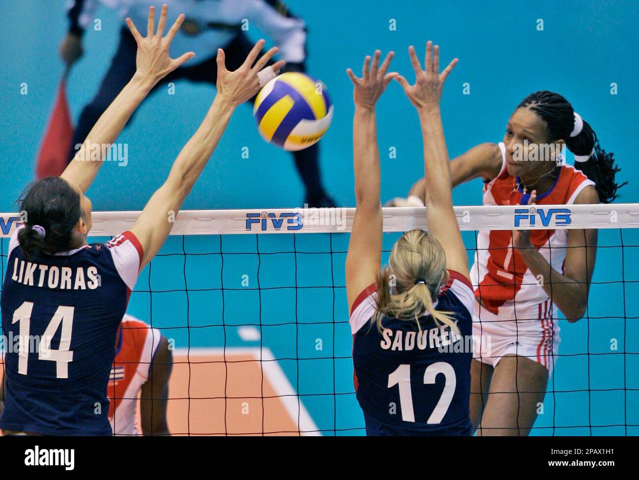Yumilka Ruiz Luaces, right, of Cuba spikes the ball against Maria ...