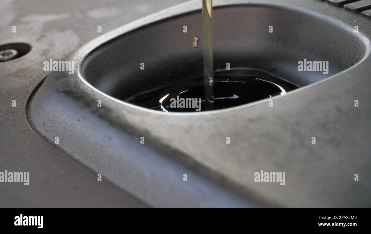 Motor oil pouring to car engine Stock Photo - Alamy