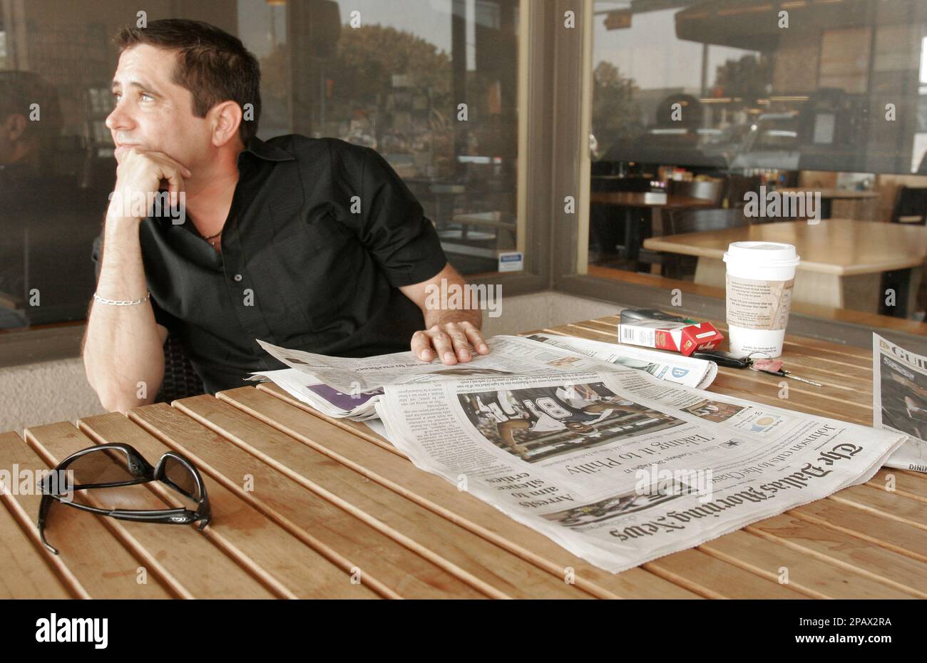 Victor Hernandez, 43, pauses while reading a newspaper at a Dallas ...
