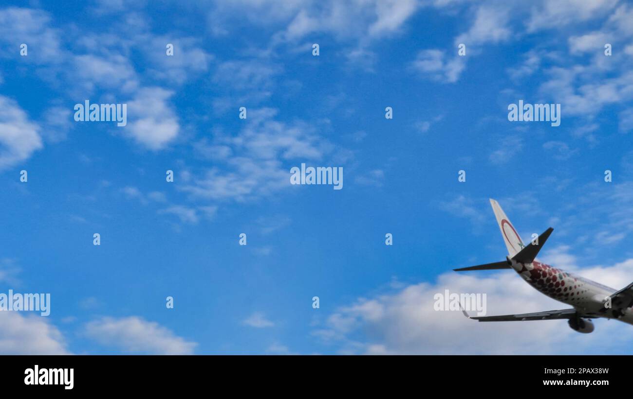 modern airplane tail side view isolated on blue sky part of passenger ...