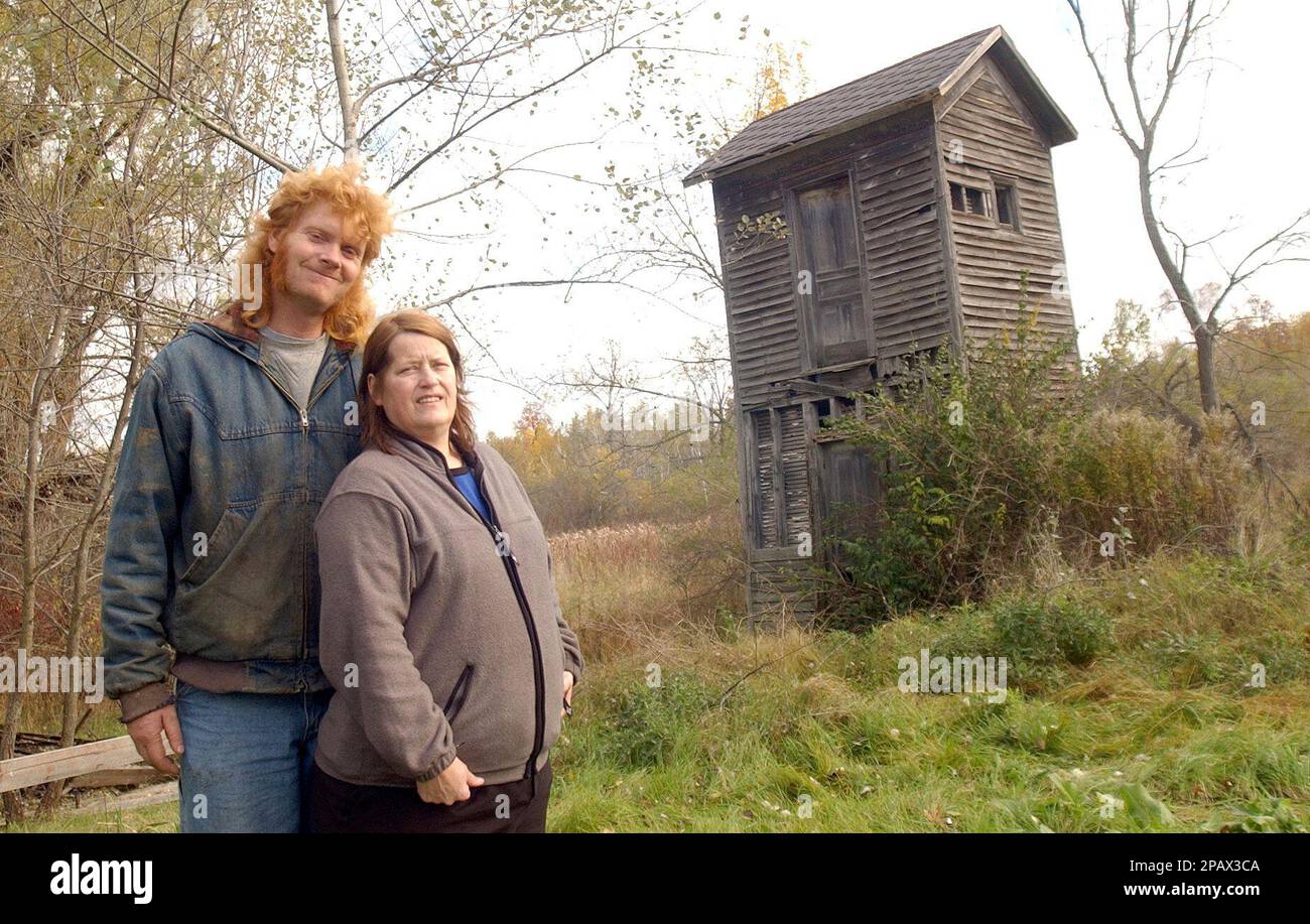 Matt and Vicki Cole stand in front of the two-story outhouse they own ...