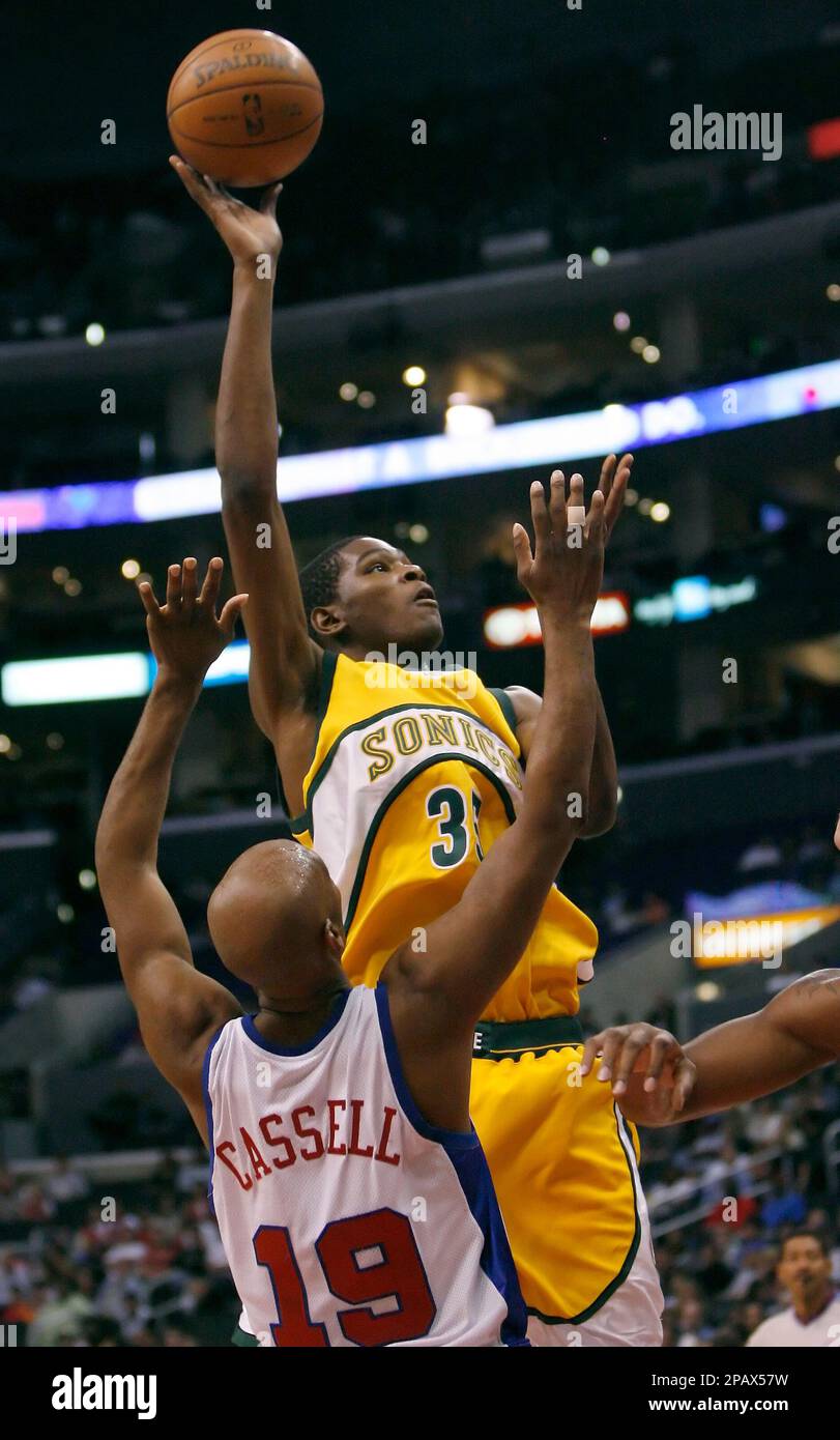 Seattle SuperSonics' Kevin Durant, top, shots over Los Angeles Cippers ...