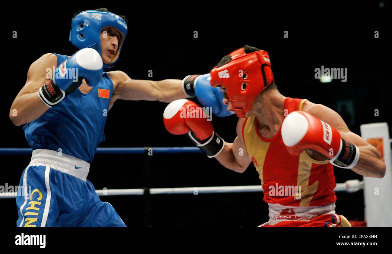 Shiming Zou, left, of China, punches Harry Tanamor, of the Philippines ...
