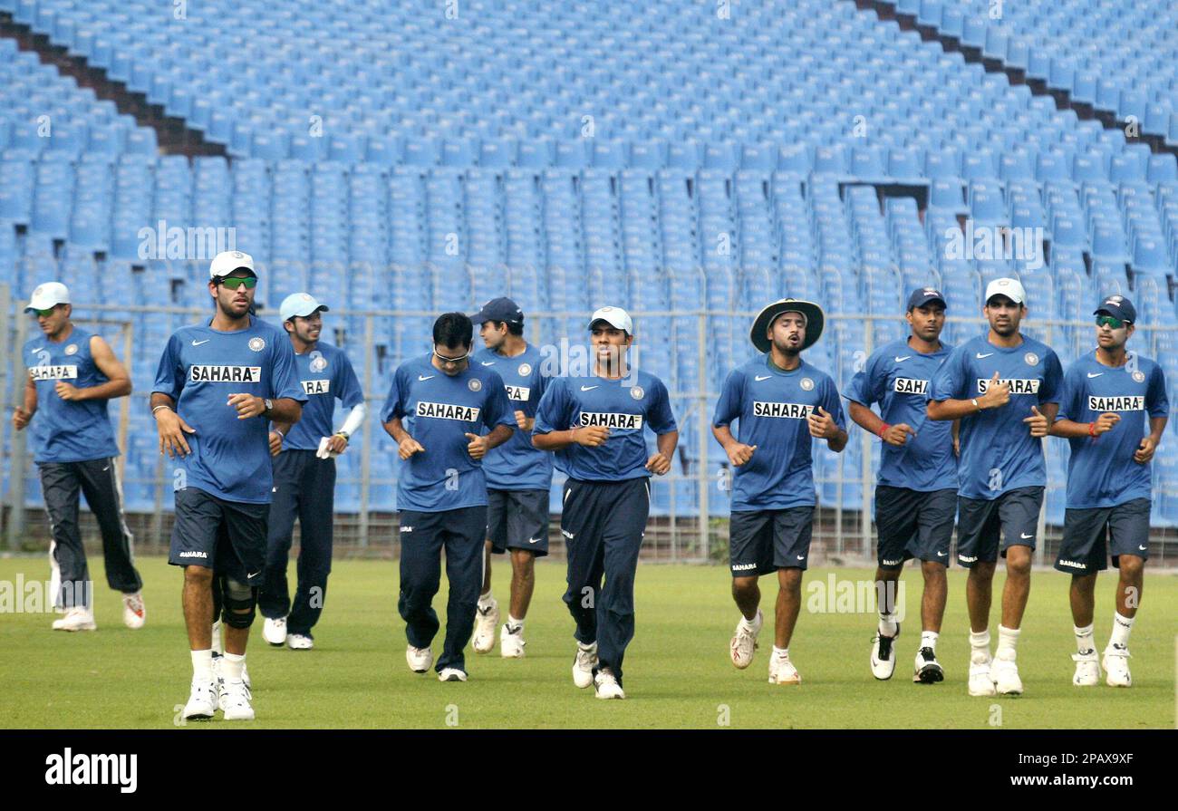 Indian cricket players run during a pre-match training session in ...