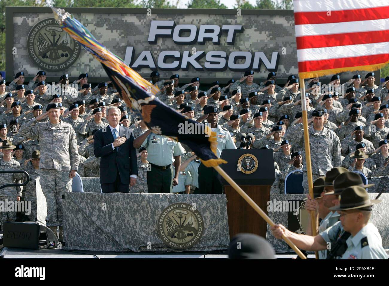 President Bush, second from the left, holds his hand to his heart as ...