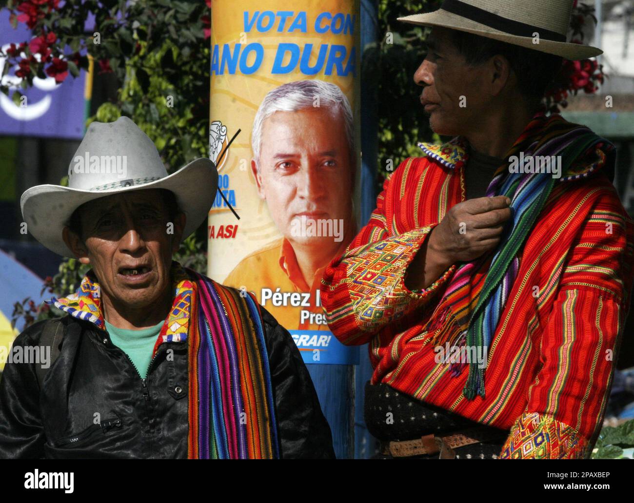 Men stand next to an election poster for presidential candidate Otto ...
