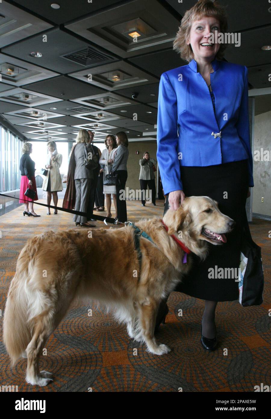 Debbie Parkhurst, of North East, Md., stands beside her golden ...