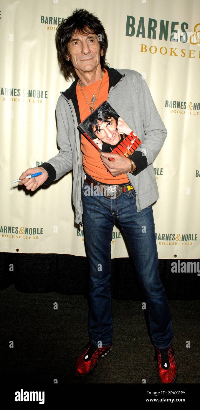 Rolling Stones guitarist Ronnie Wood poses with his new book, an ...