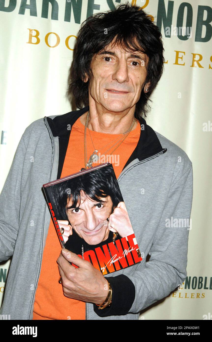 Rolling Stones guitarist Ronnie Wood poses with his new book, an ...