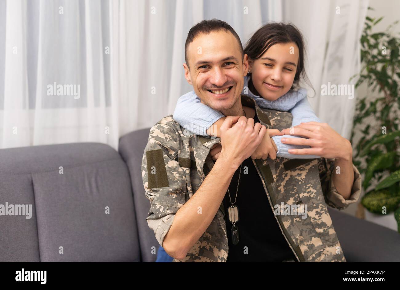 pretty little girl hugging her military father Stock Photo - Alamy