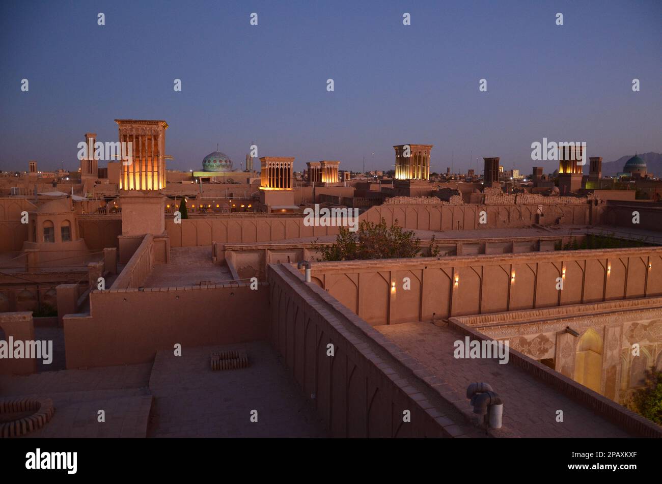 panorama form the city of Yazd in sunset with buildings and wind towers ...