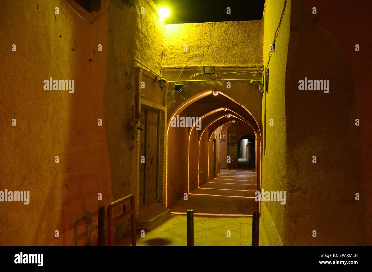 small beautiful illuminated alley through the mud walls of Yazd, Iran ...