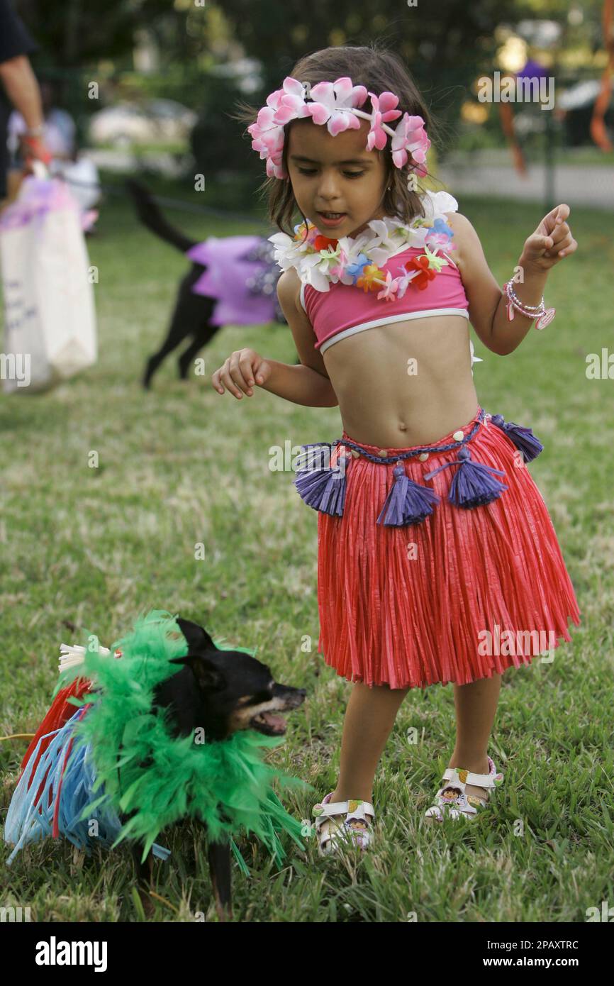 Sabrina, left, a mini pinscher, and Giselle Mayer, 3, dance at a dog ...