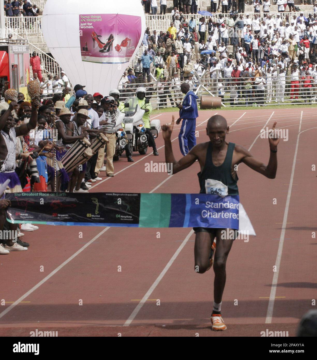 Kenya's John Njoroge celebrates as he approaches the finish line of the ...