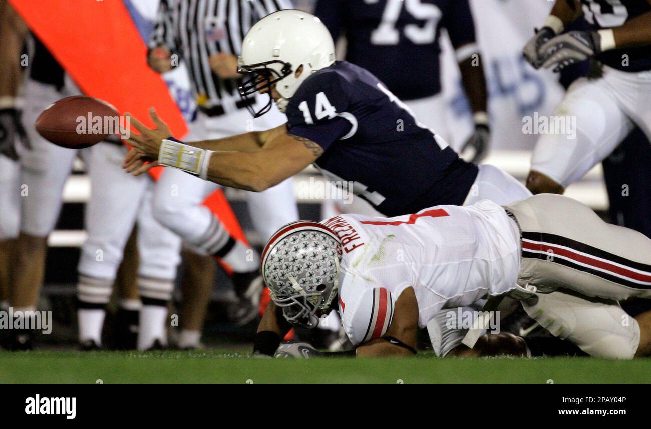 Penn State quarterback Anthony Morelli fumbles the ball as he is ...