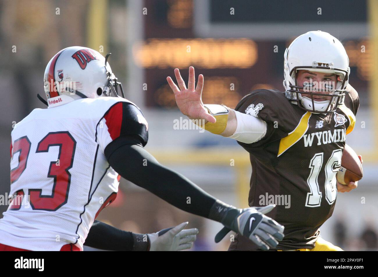 Wyoming quarterback Karsten Sween tries to get away from UNLV defender ...