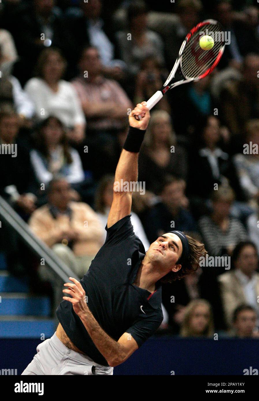 Roger Federer of Switzerland serves against Ivo Karlovic of Croatia ...