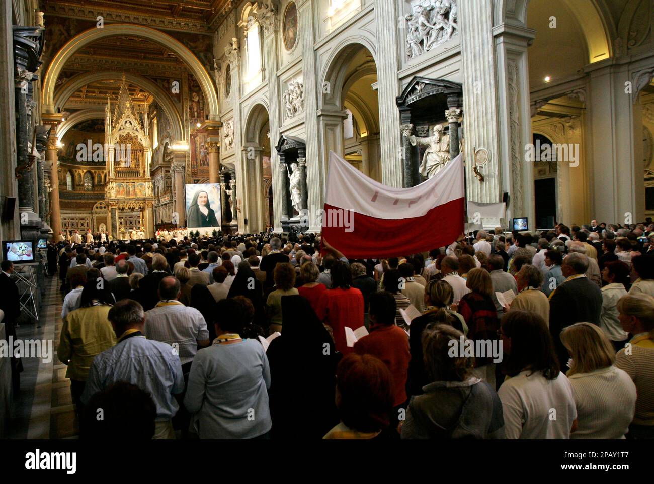 A Polish flag is held by faithful attending the beatification ceremony ...