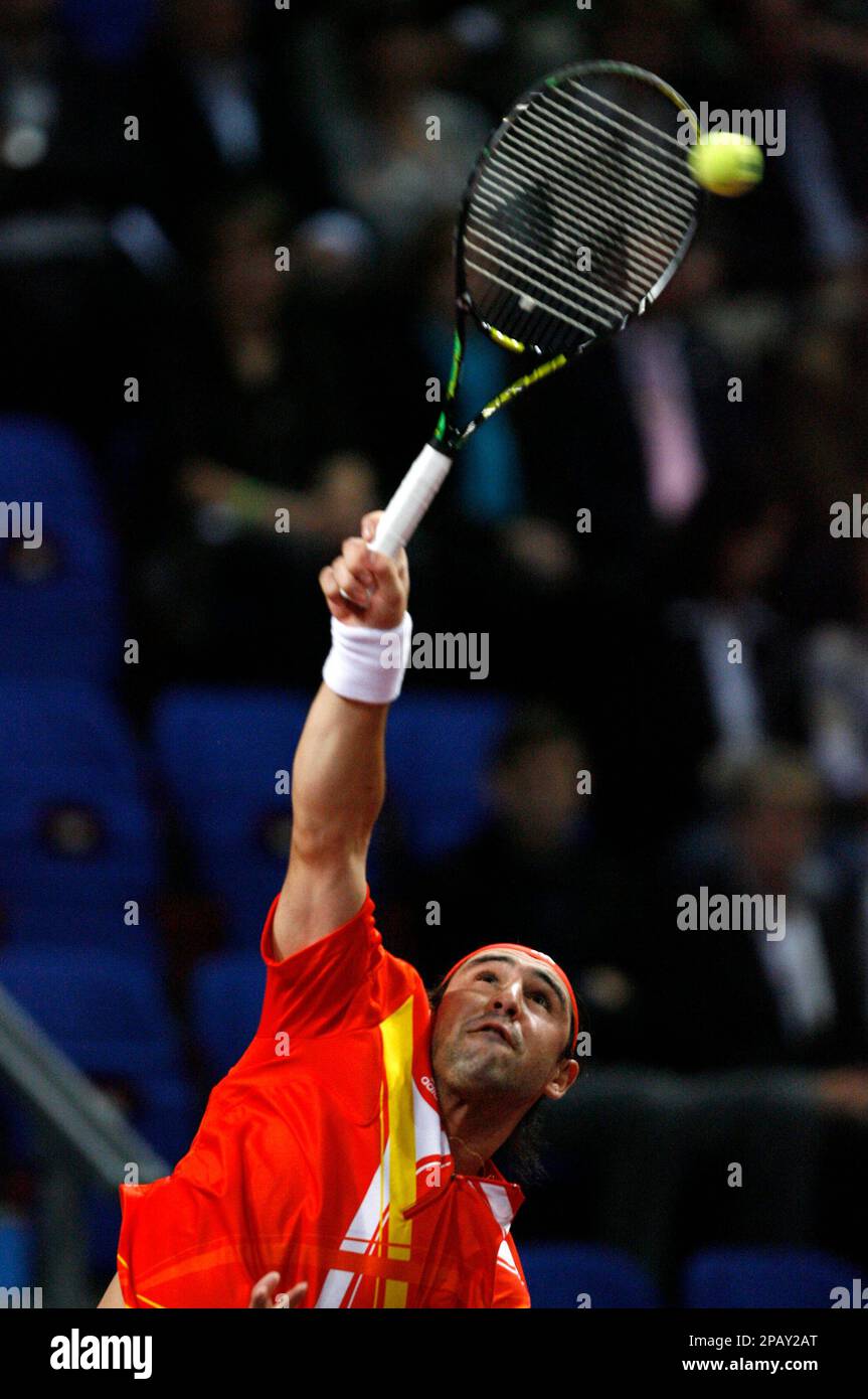 Marcos Baghdatis of Cyprus returns a ball to Jarkko Nieminen of Finland ...