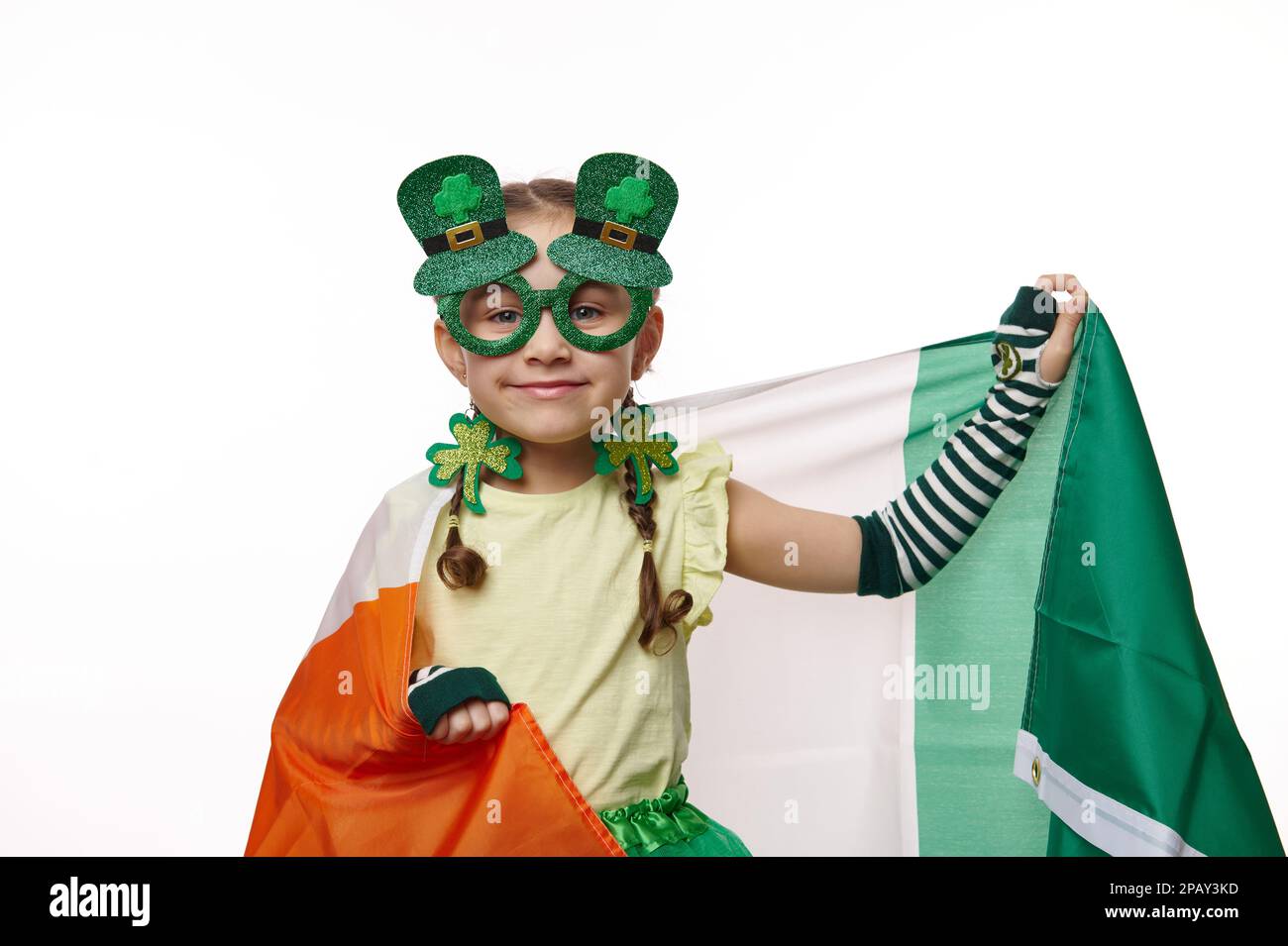 Funny kid looking at camera through carnival glasses in the shape of ...