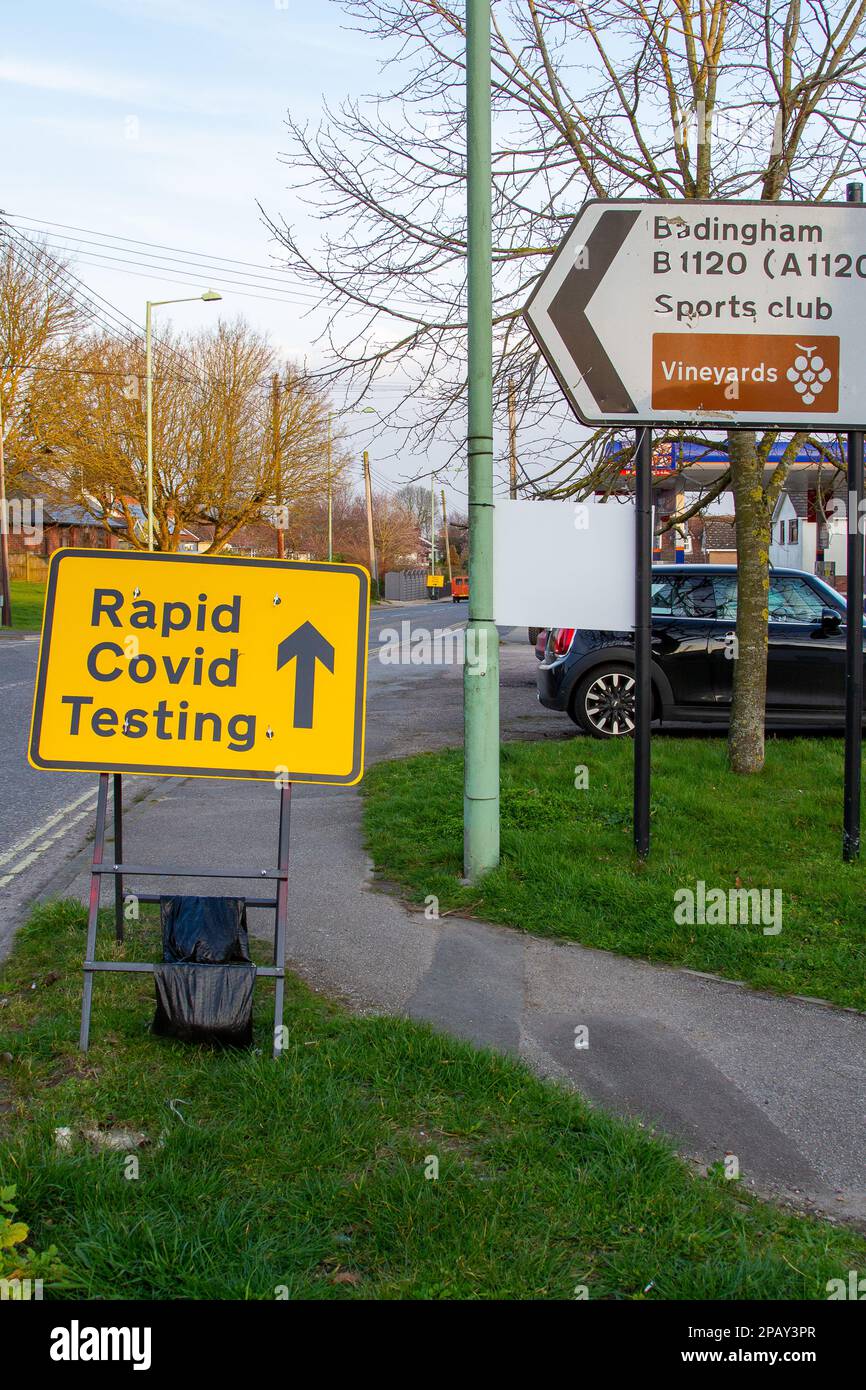 Temporary yellow roadside sign with direction arrow to rapid covid ...