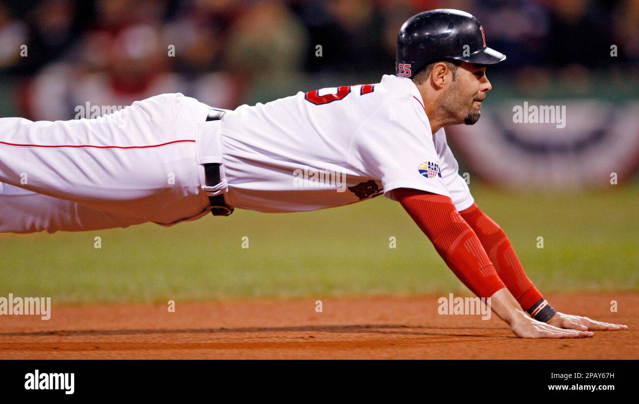Boston Red Sox's Mike Lowell slides into third, running from first on a ...