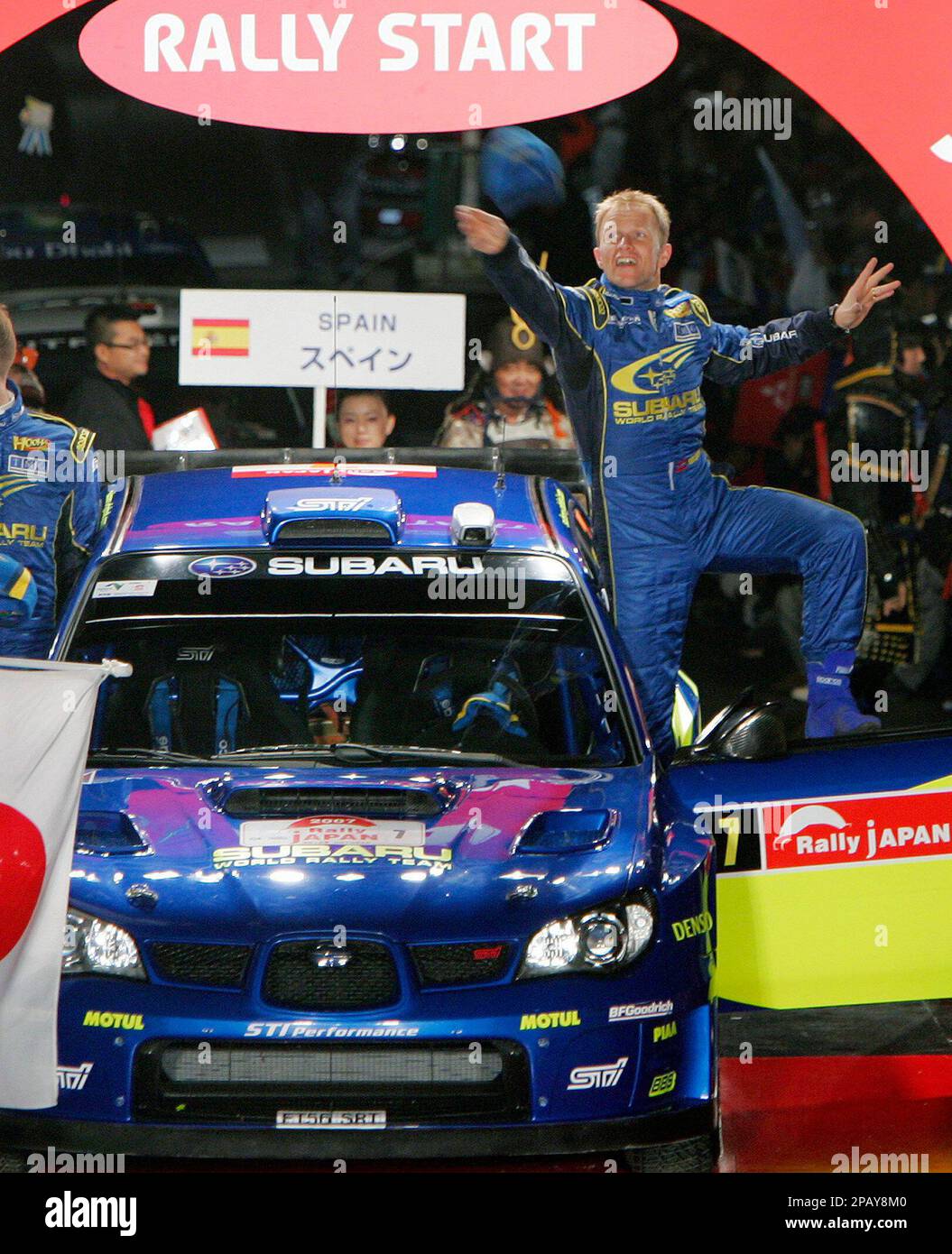 Norway's Petter Solberg throws a cap to fans from his Subaru Impreza ...