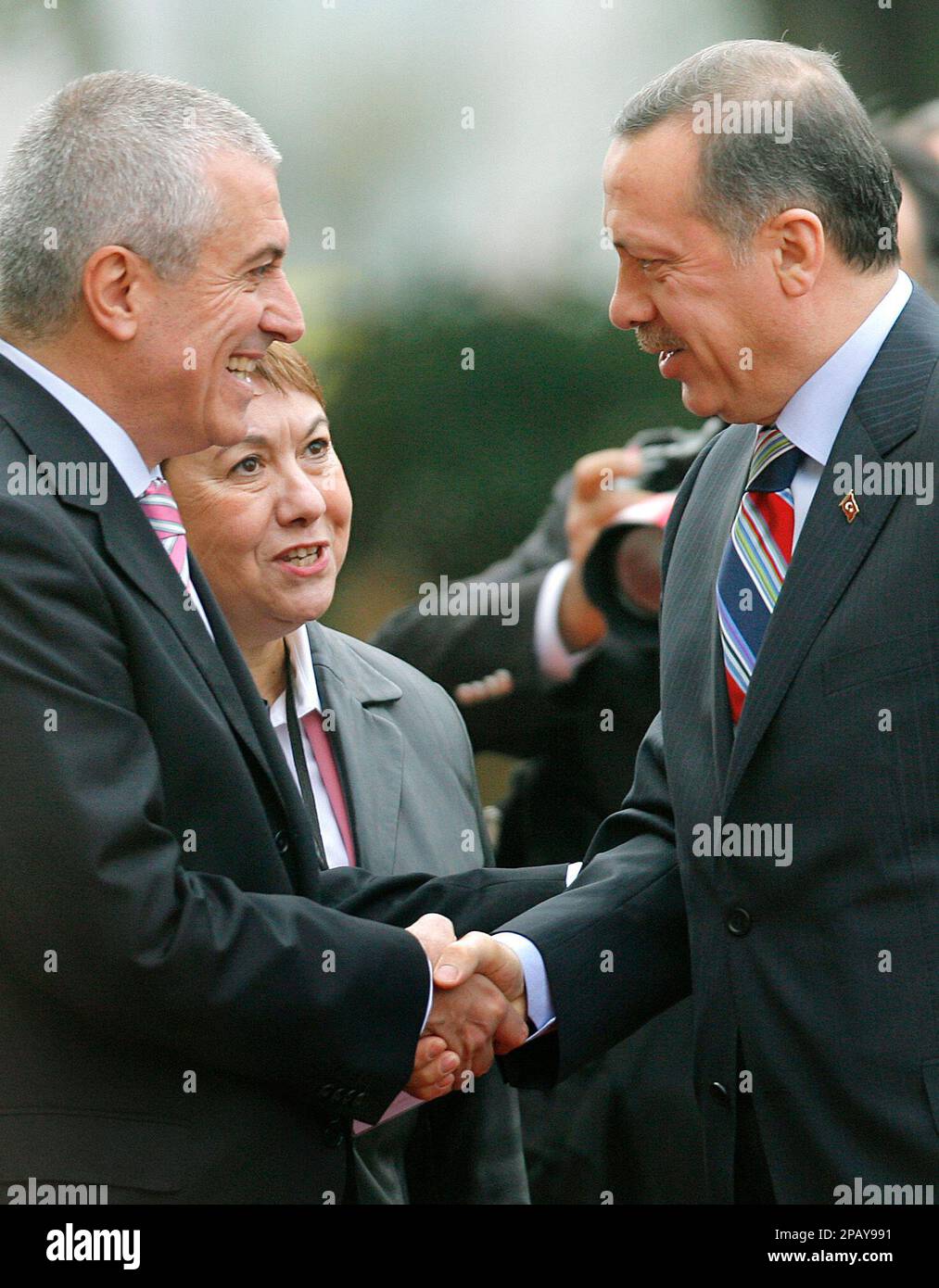 Turkish Prime Minister Recep Tayyip Erdogan, right, shakes hands with ...