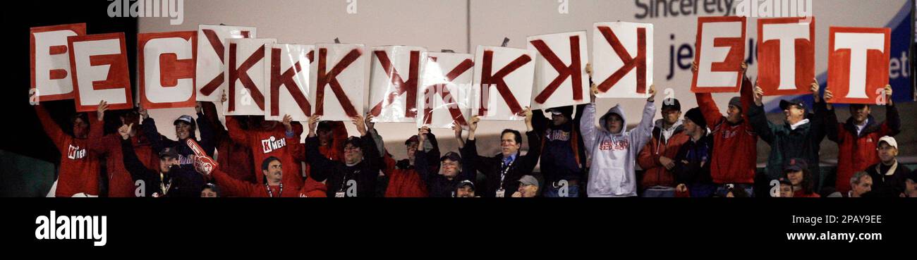 Fans celebrate as Boston Red Sox starting pitcher Josh Beckett is ...