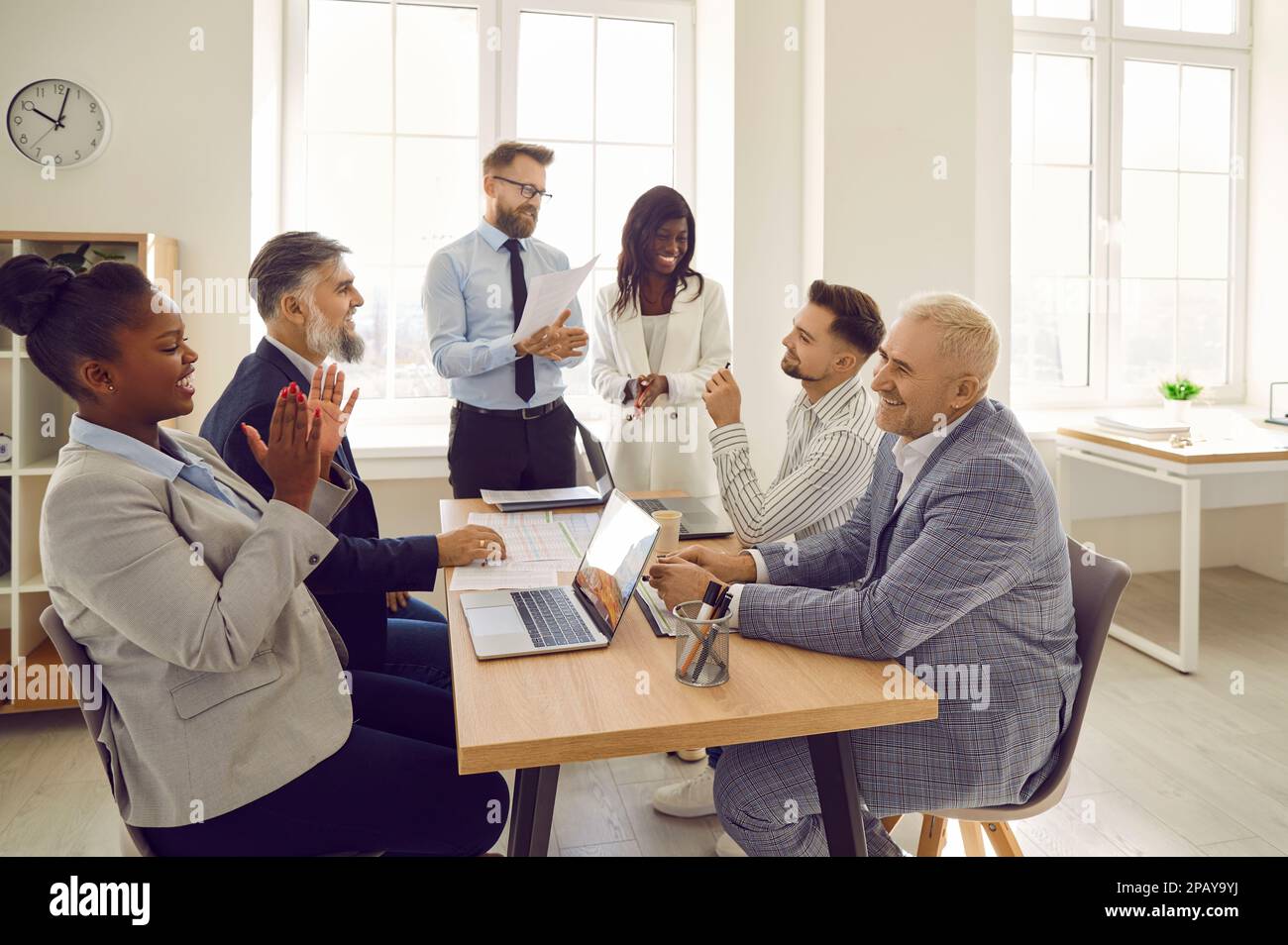 Diverse corporate business team laughing at something funny during a ...