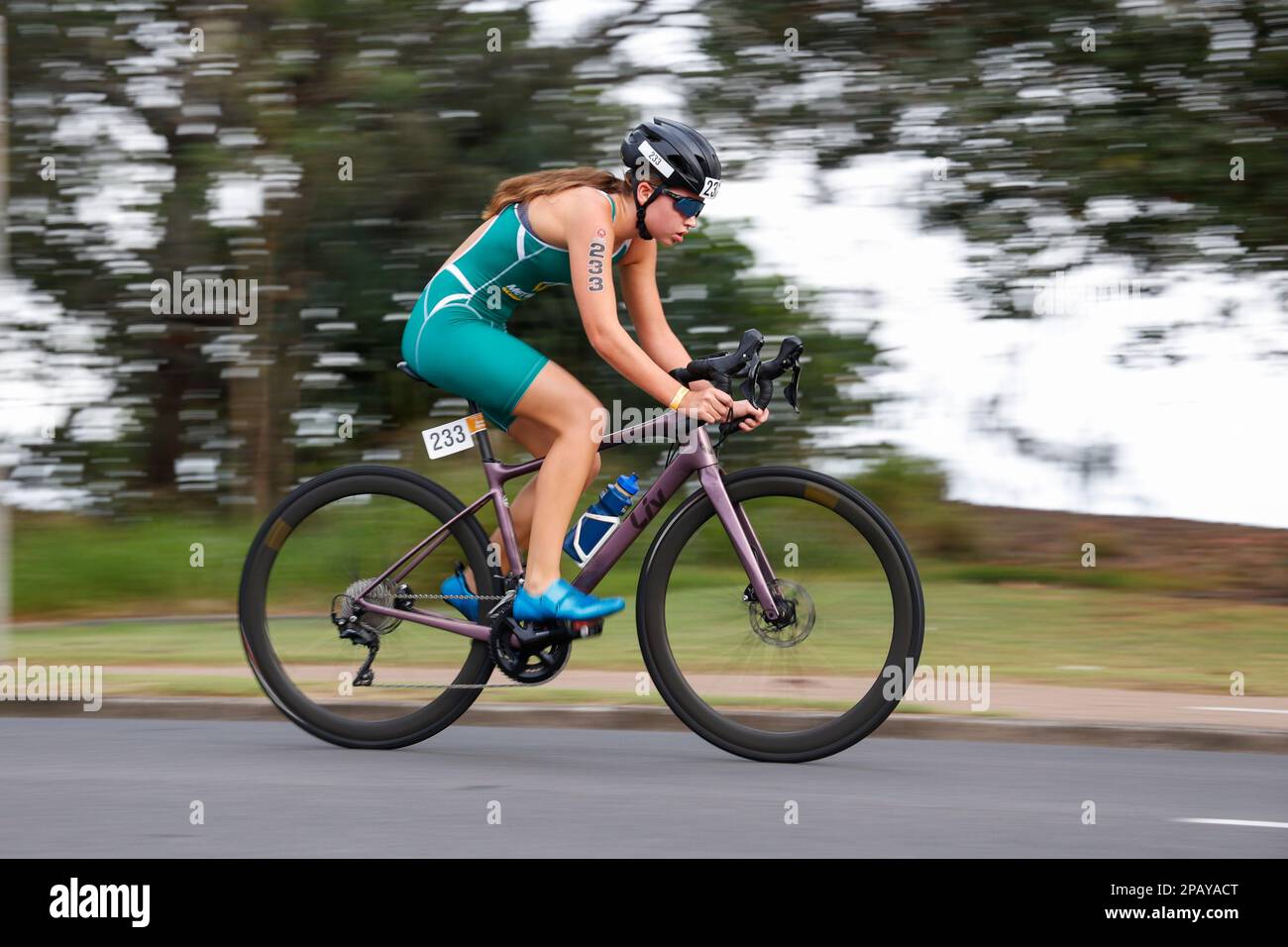 Teenage girl competitor cycling at the National Schools Triathlon in ...