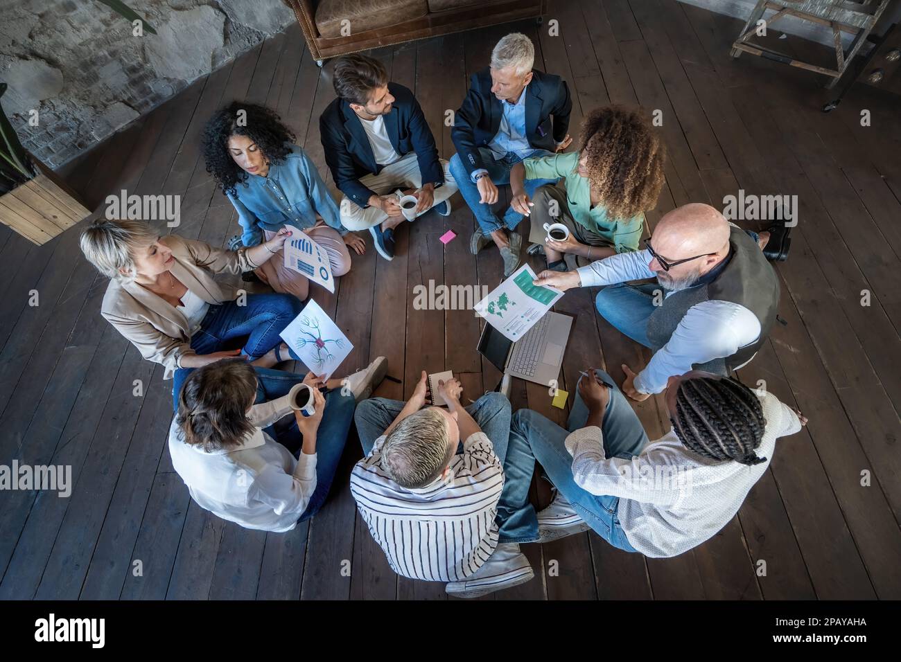 A diverse group of professionals engages in a creative brainstorming ...