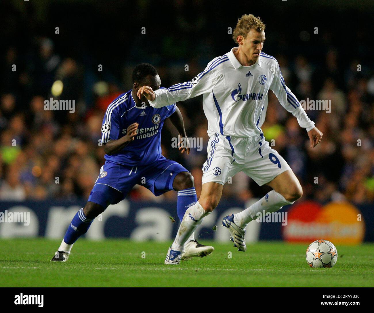 Chelsea's Michael Essien is held back by Schalke 04's Soren Larsen ...