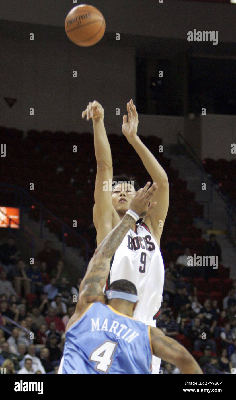 Milwaukee Bucks' Yi Jianlian (9) of China, shoots over Denver Nuggets ...