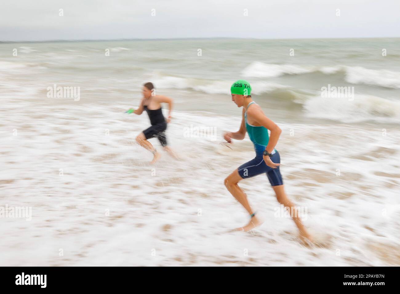 Two students sprint out of the water at the National Schools Triathlon ...