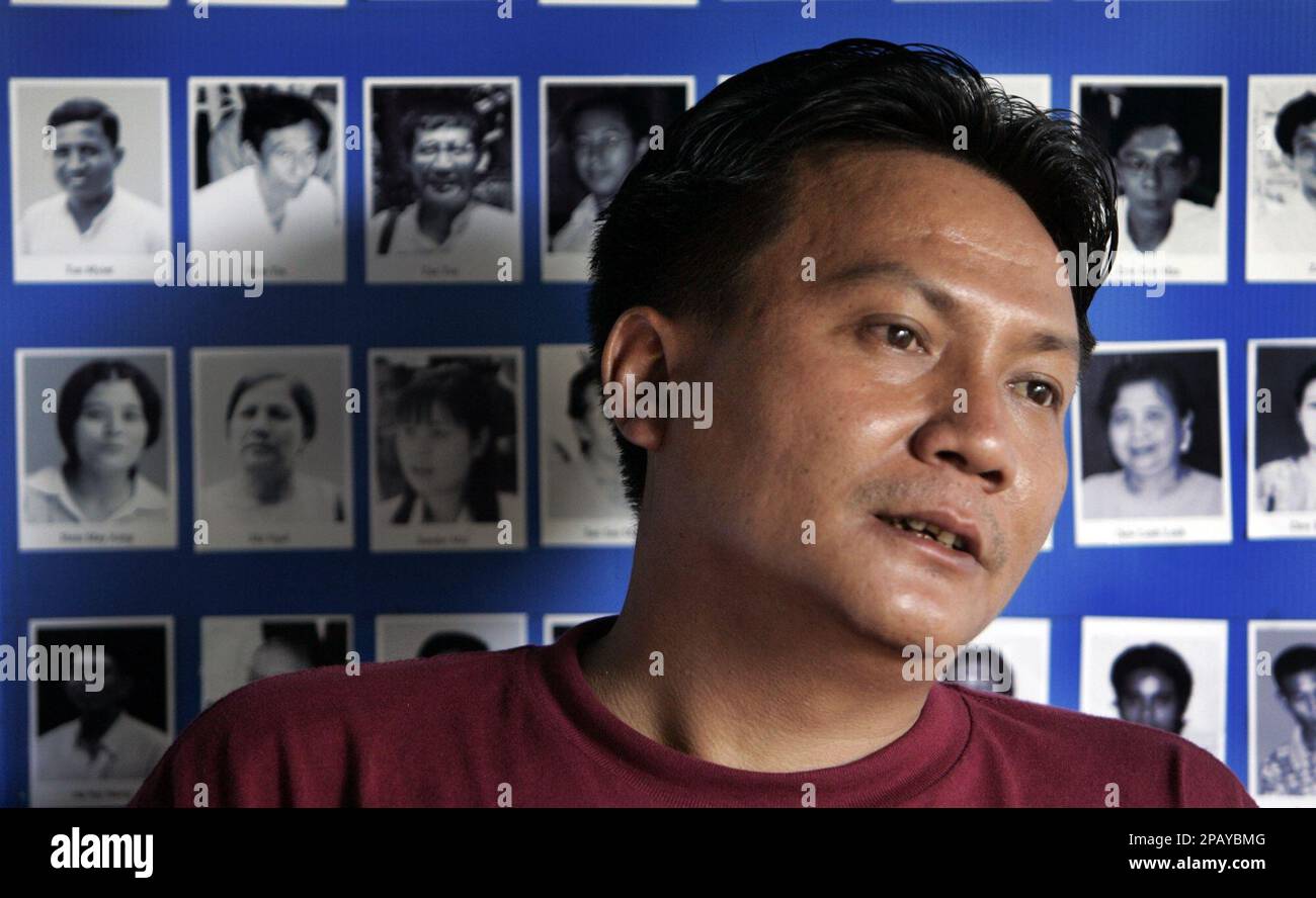 Myanmar activist Hlaing Moe Than, 37, sitting near a board of photos of ...