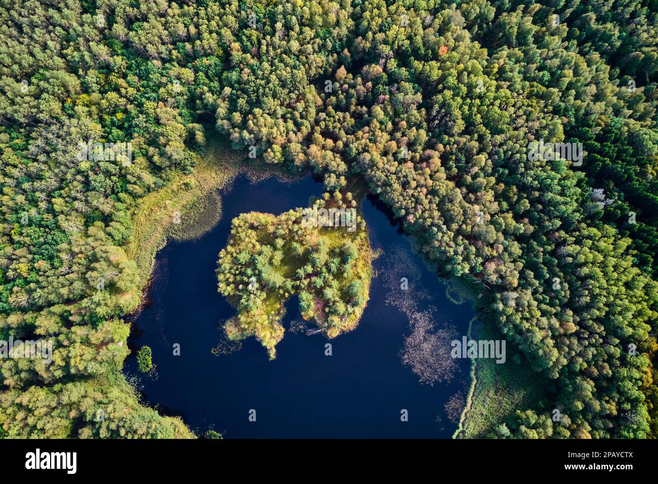 Aerial view of a picturesque landscape with a peat lake and a small ...