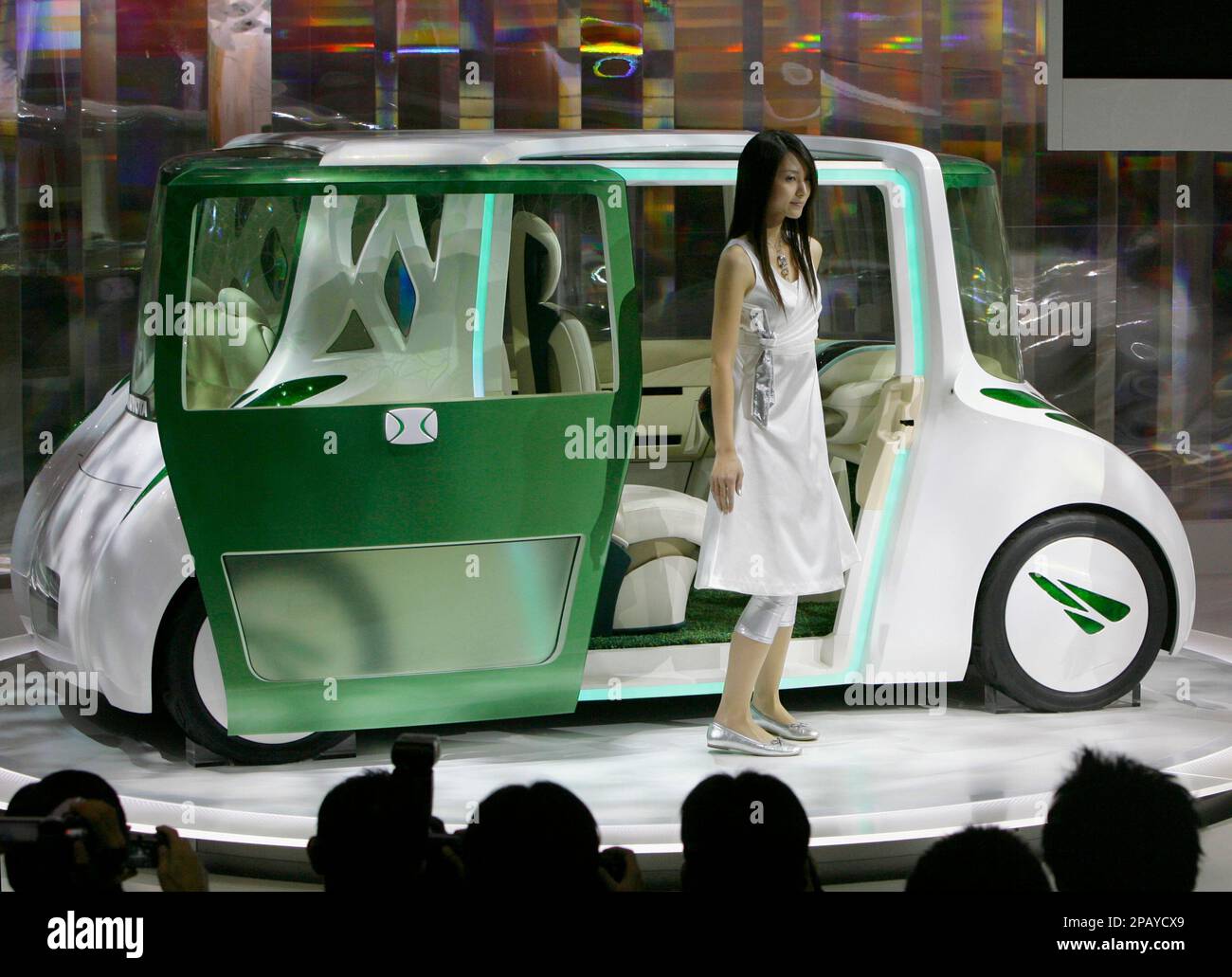 Model stands by Toyota Motor Corp.'s concept vehicle RiN at the Tokyo ...