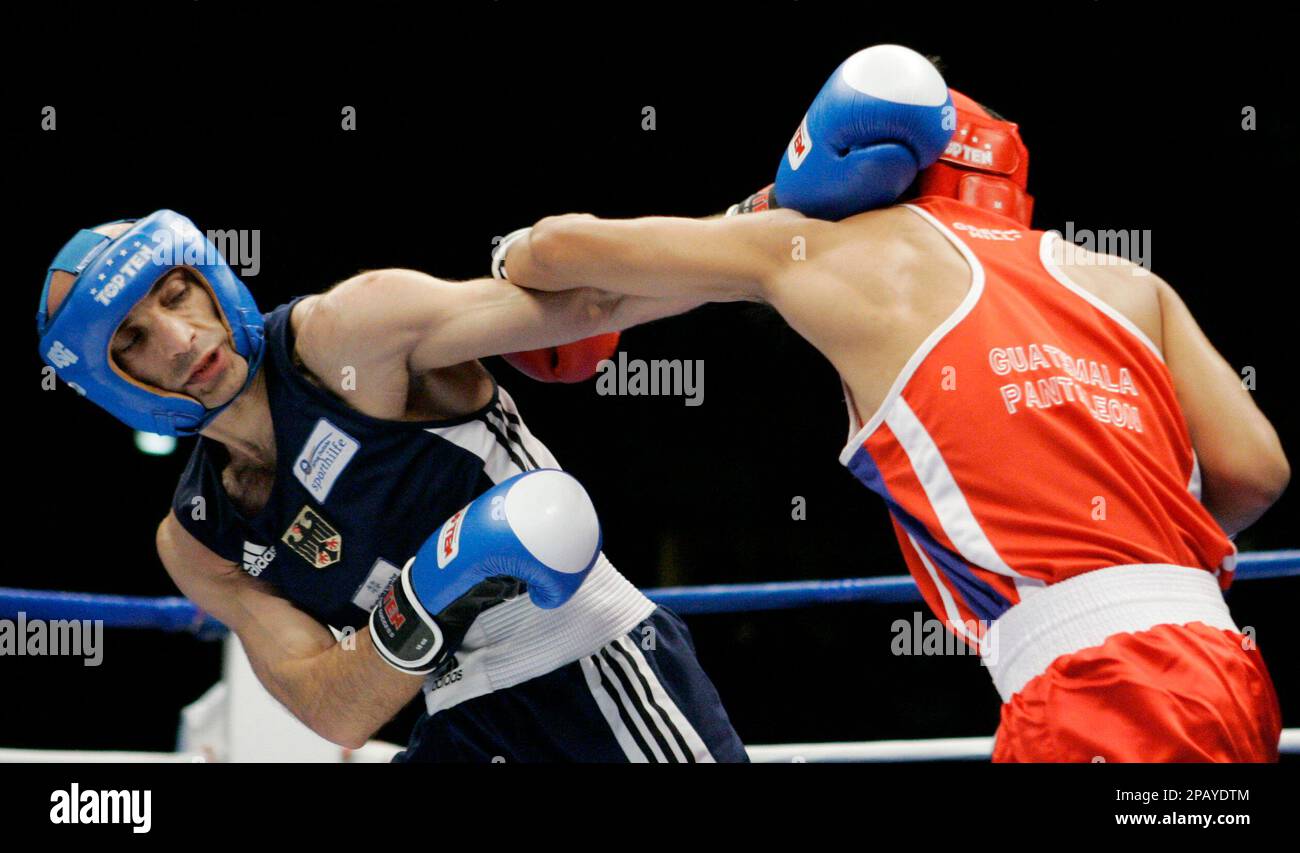 Rustam Rahimov, from Germany, left, ducks from the punch of Jose ...