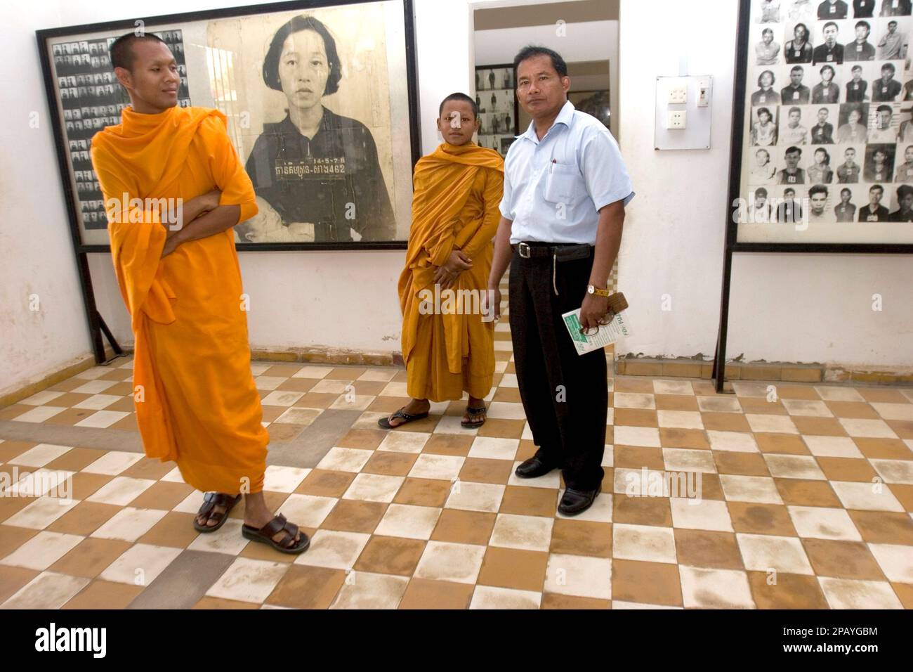 Nhem En, 47, right, former chief photographer at a torture center run ...