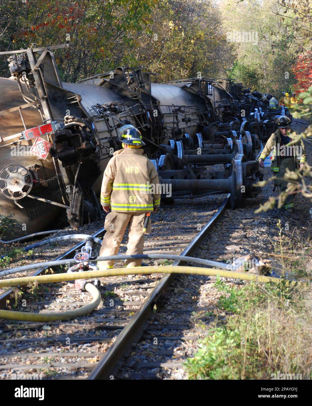 Hazardous waste teams work to clean up the spill after a freight train ...