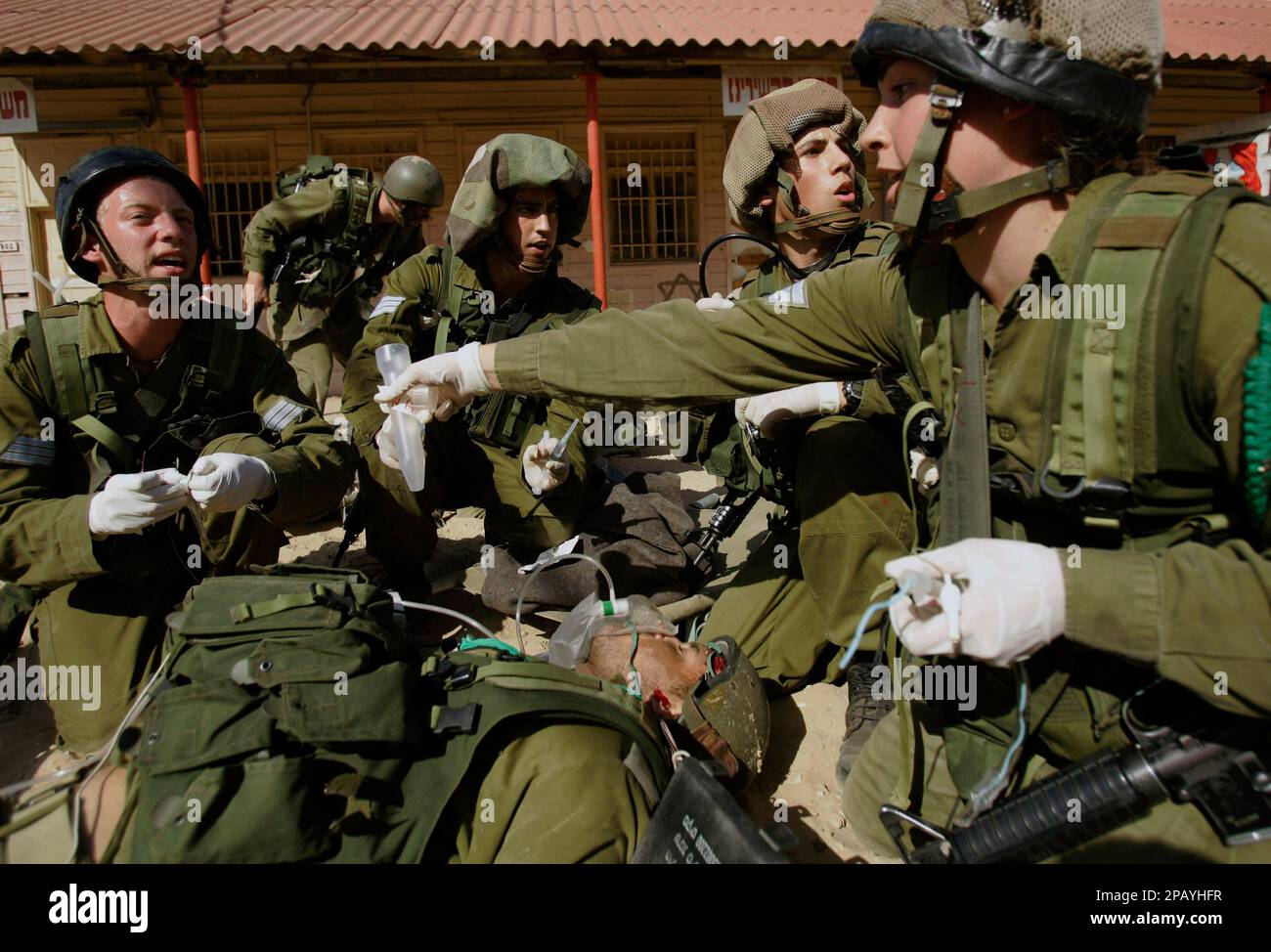 Israeli soldiers simulate treating a wounded soldier during a drill of ...