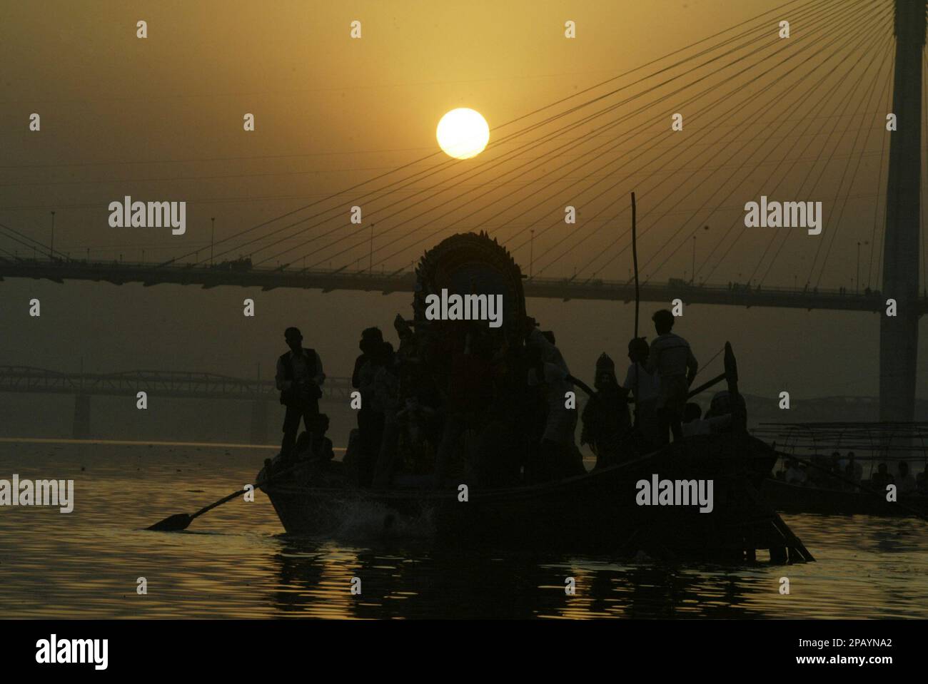 Indian Hindu devotees carry Goddess Durga's idol on a boat for ...