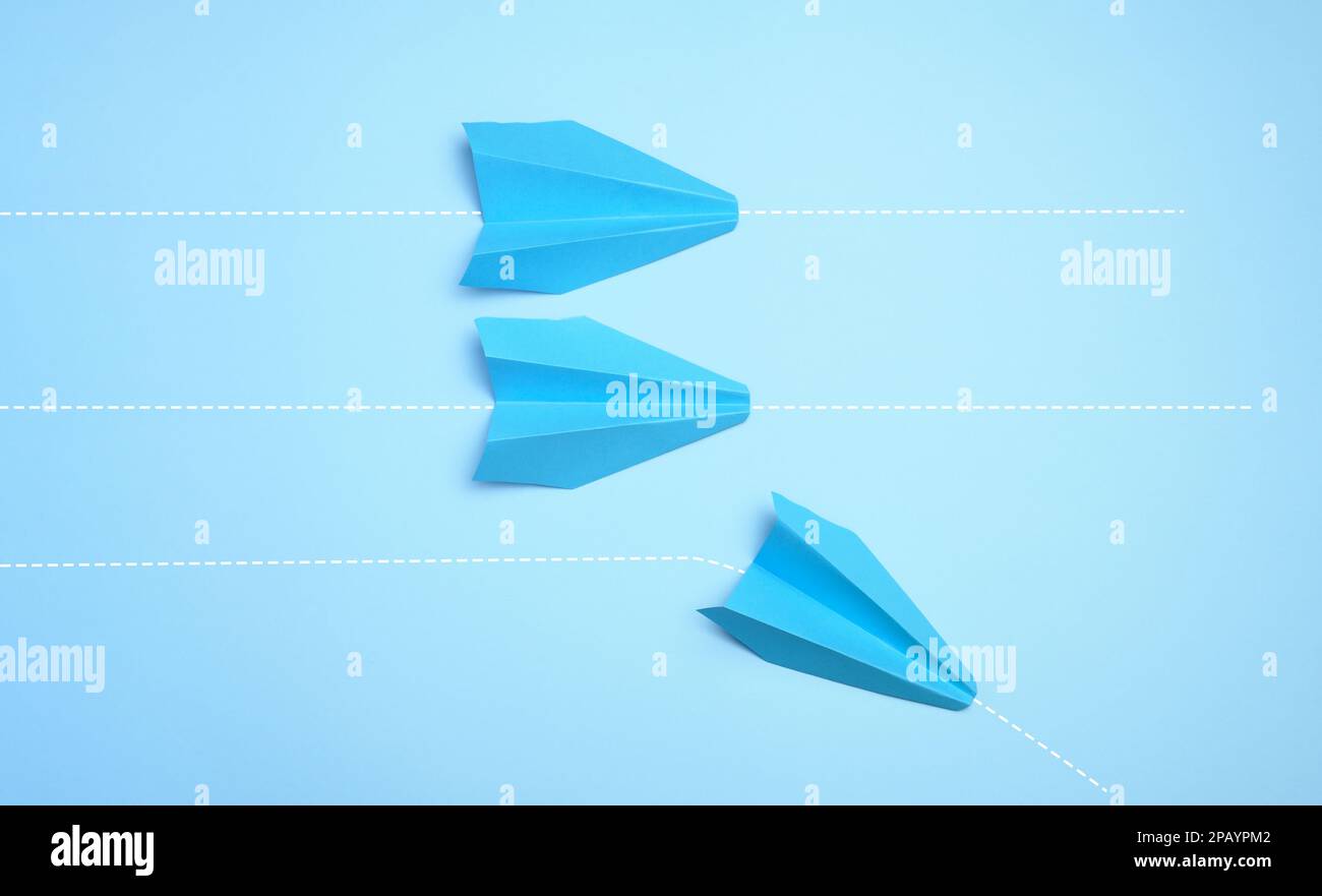 Three paper airplanes are moving forward, one turned sideways ...