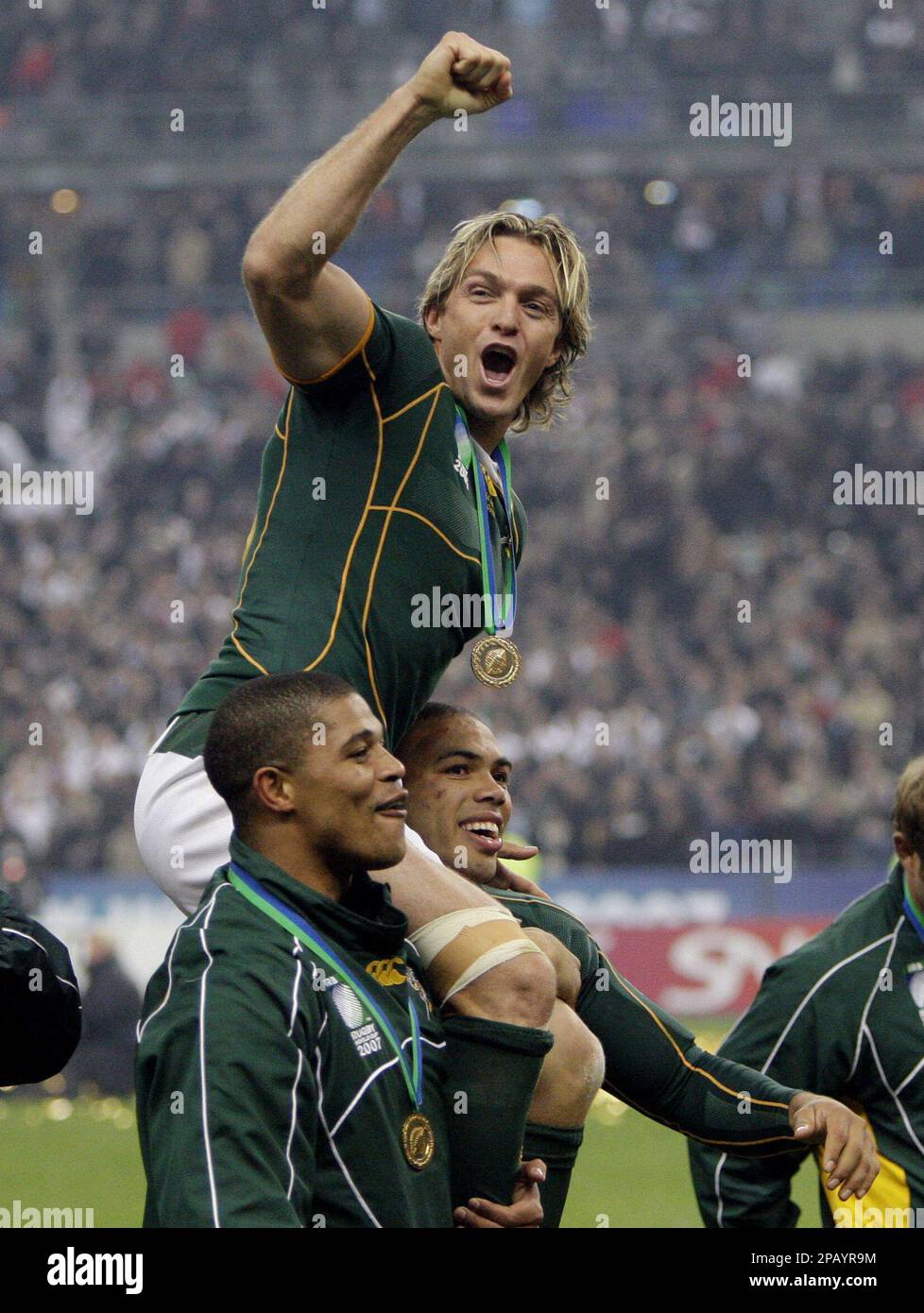 South African fullback Percy Montgomery is carried around the field by ...