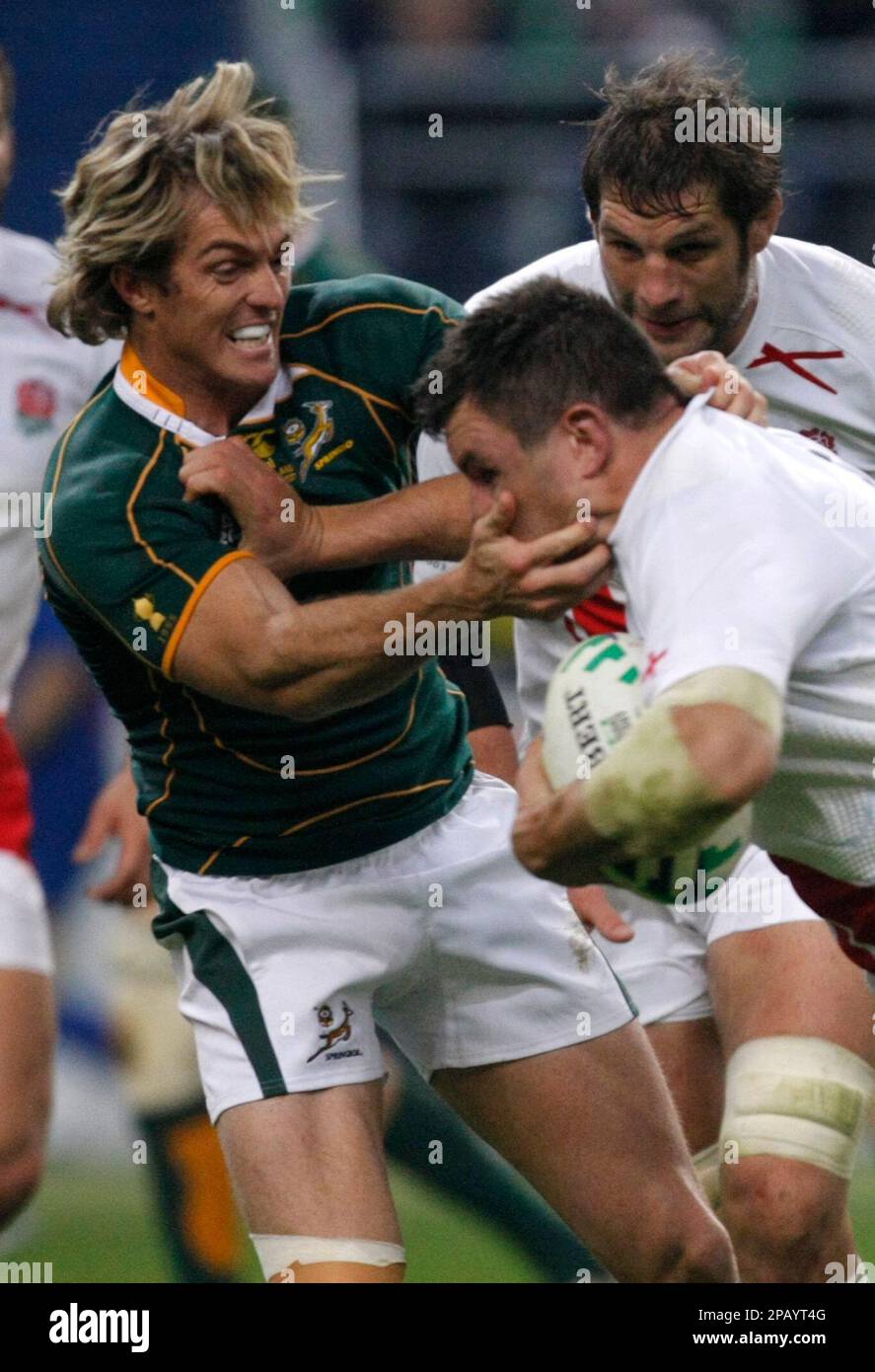 South Africa's Percy Montgomery, left, grabs England's Martin Corry ...