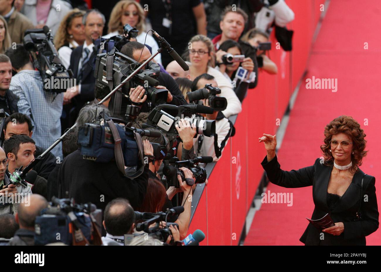 Italian movie legend Sophia Loren waves as she walks the red carpet at ...