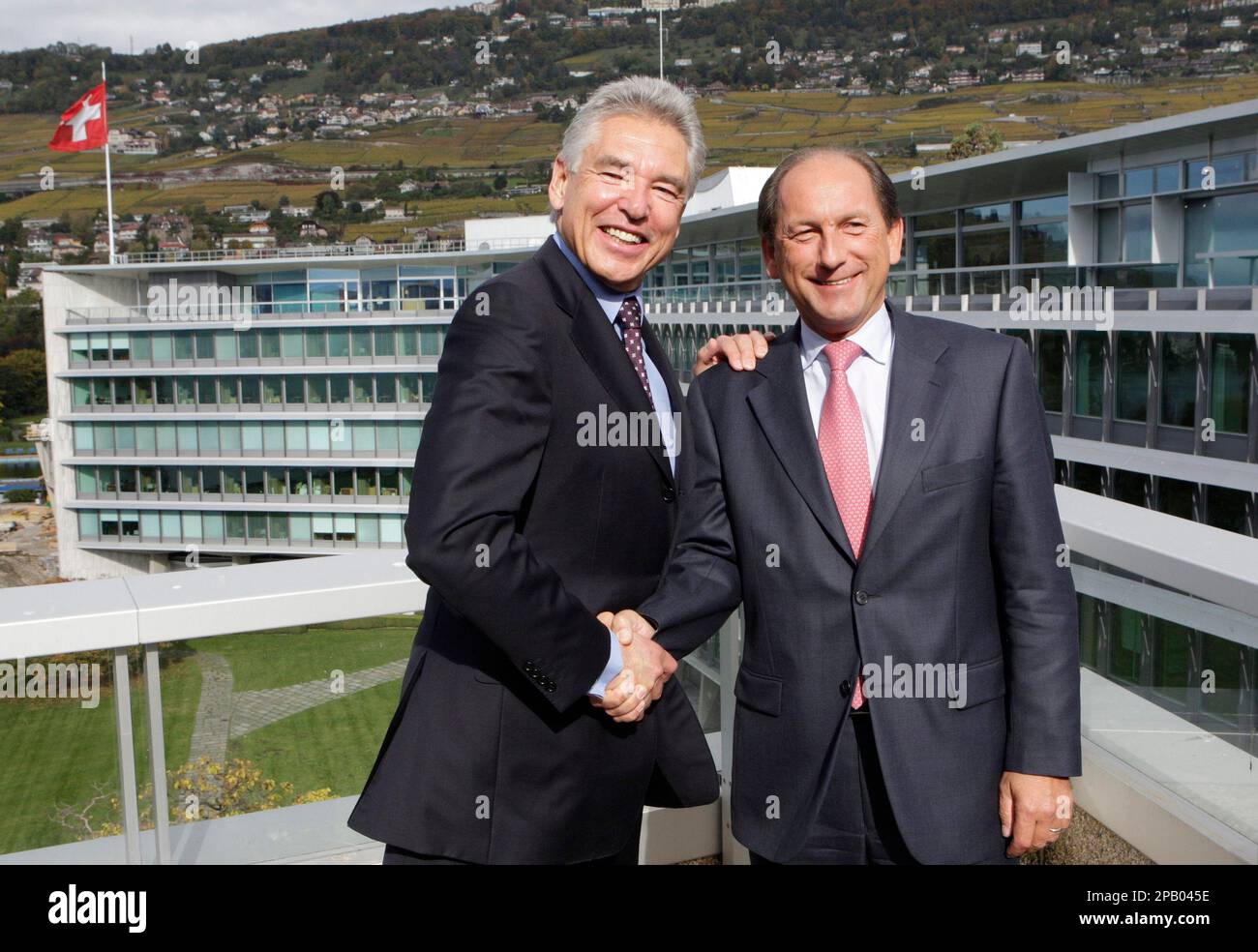 Nestle's Chairman and CEO Peter Brabeck-Letmathe, left, shakes hands ...